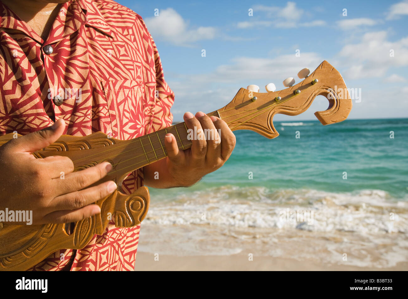 Pacific Islander man playing instrument at beach Stock Photo - Alamy