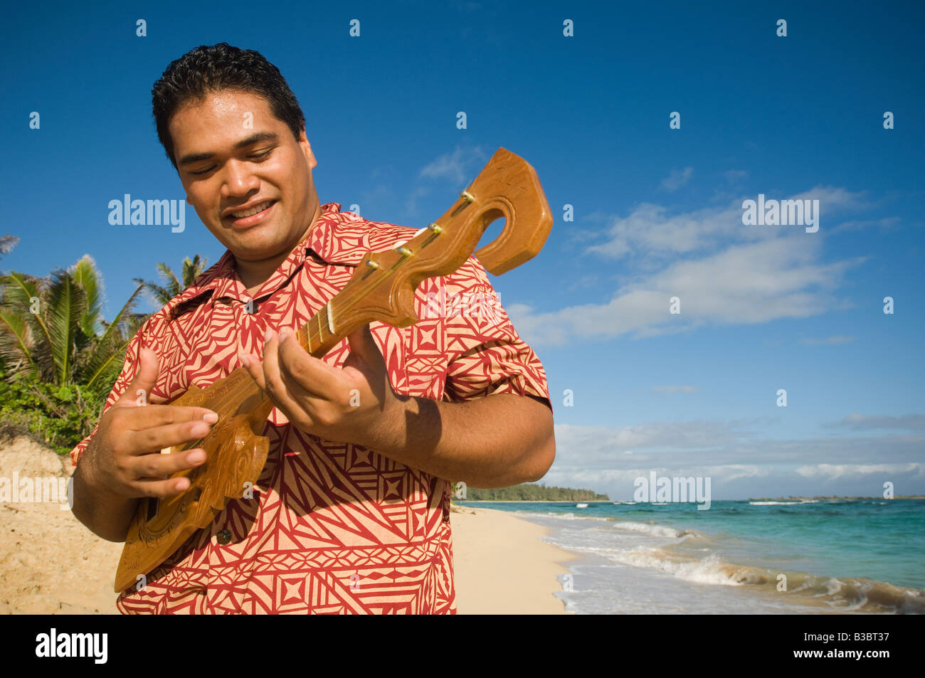 Pacific Islander man playing instrument at beach Stock Photo - Alamy