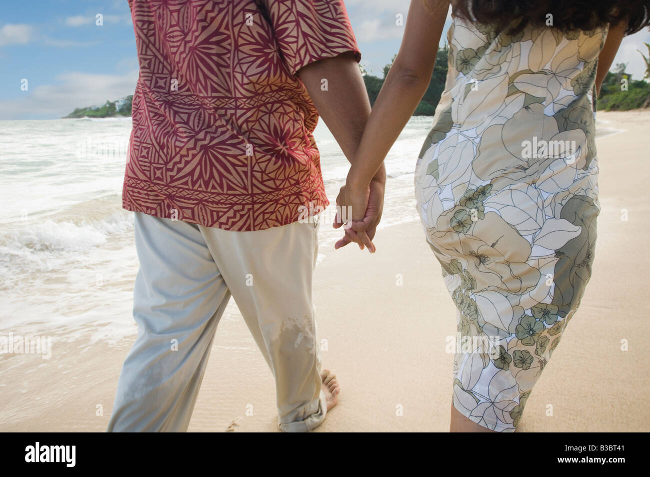 Pacific Islander couple walking on beach Stock Photo - Alamy