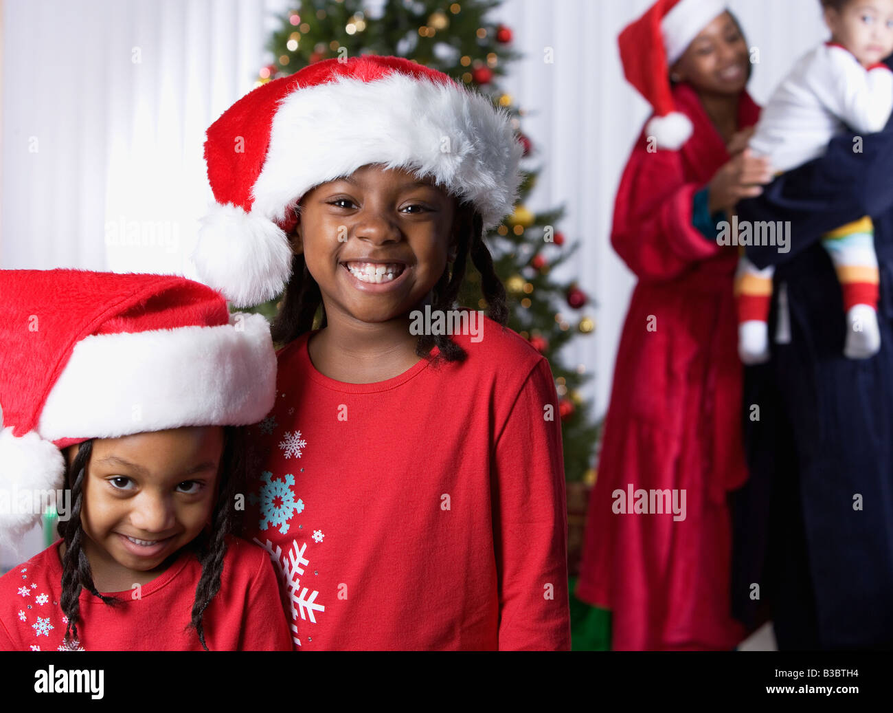 Two children wearing santa hat hi-res stock photography and images - Alamy