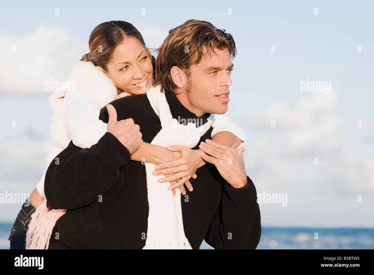 Hispanic man giving girlfriend piggy back ride Stock Photo - Alamy
