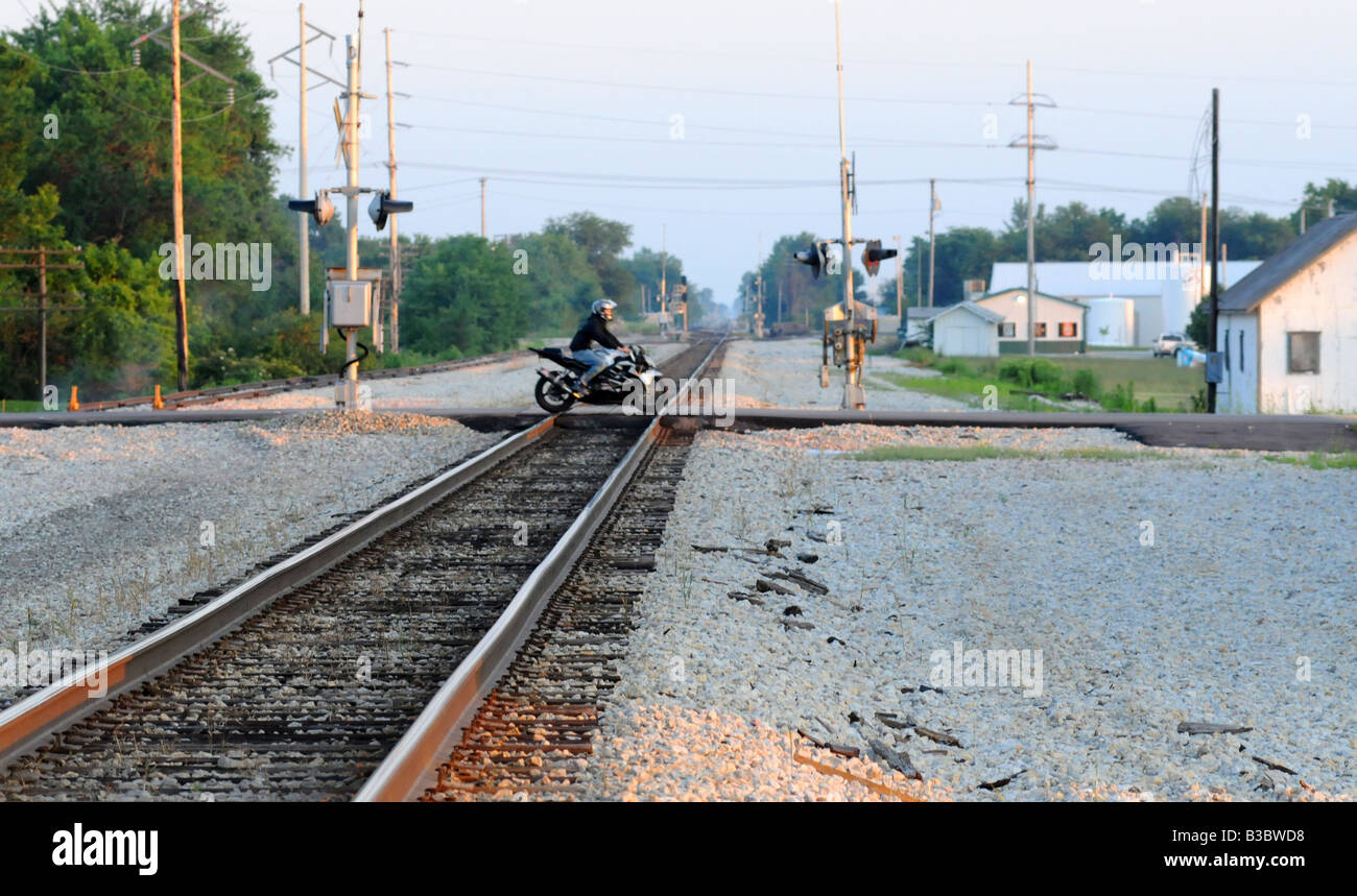 A rural railroad crossing of the CN train line being crossed by a ...