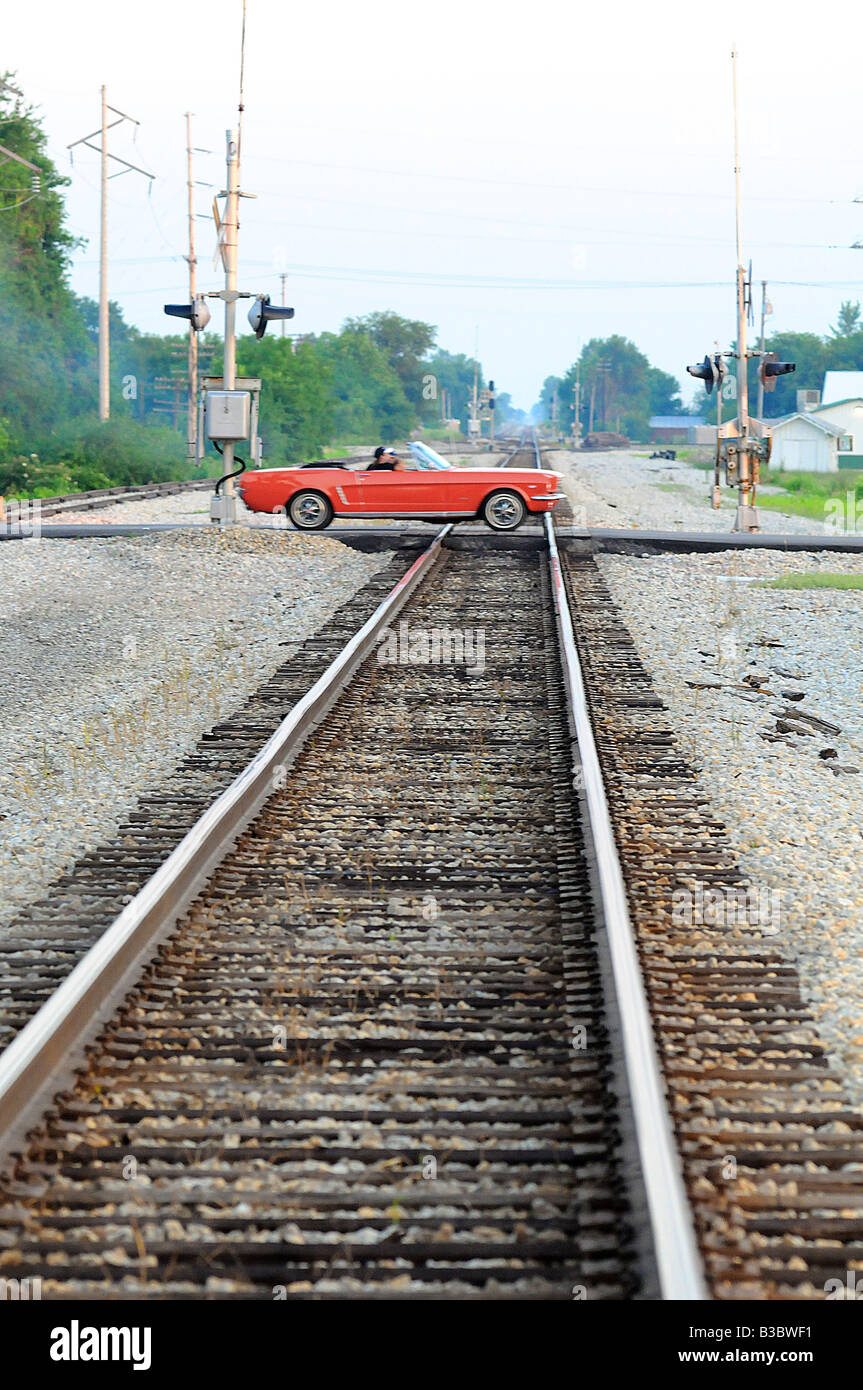 A rural railroad crossing of the CN line being crossed by a vintage ...