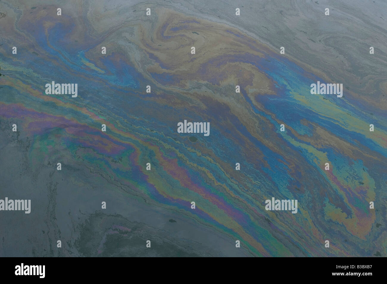 Coloured pattern of oil floating on the water in Portpatrick Harbour ...