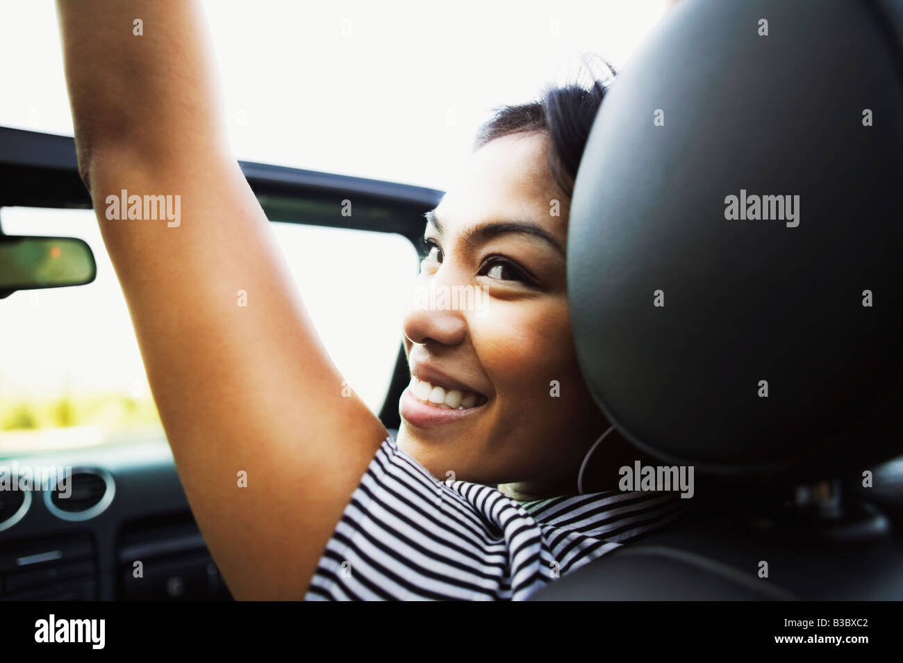 Asian woman in convertible car Stock Photo - Alamy