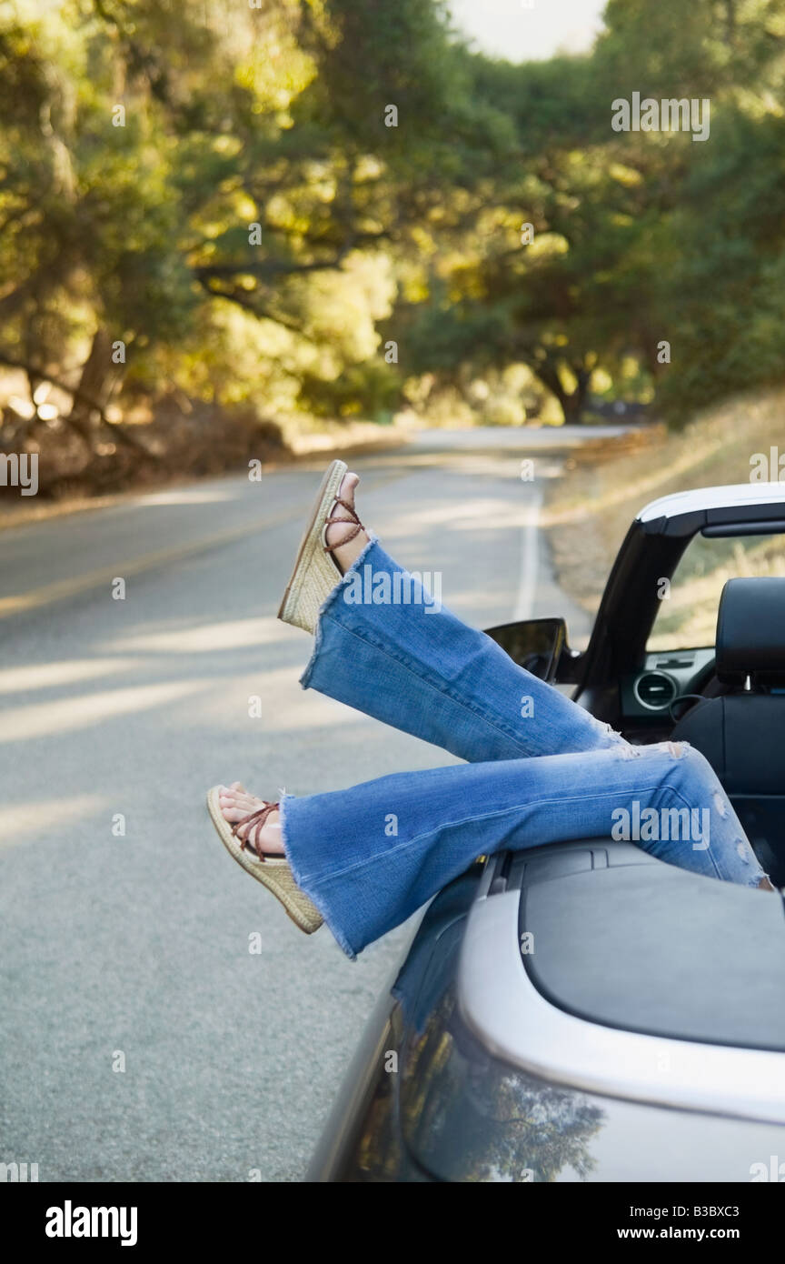 Asian woman’s feet hanging out of convertible car Stock Photo - Alamy