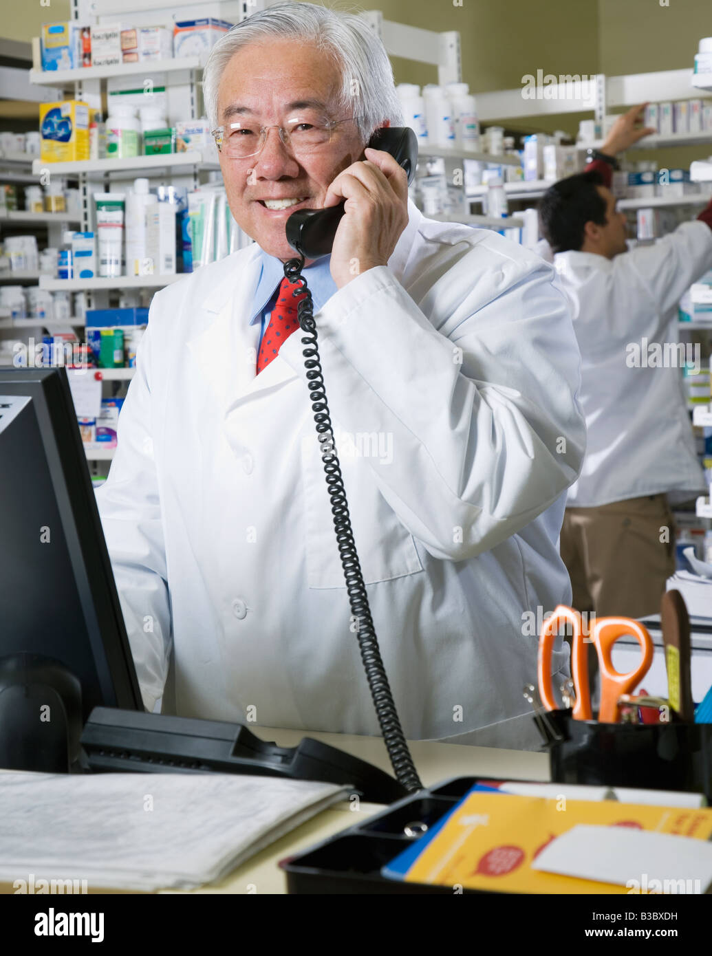 Happy pharmacist on phone hi-res stock photography and images - Alamy