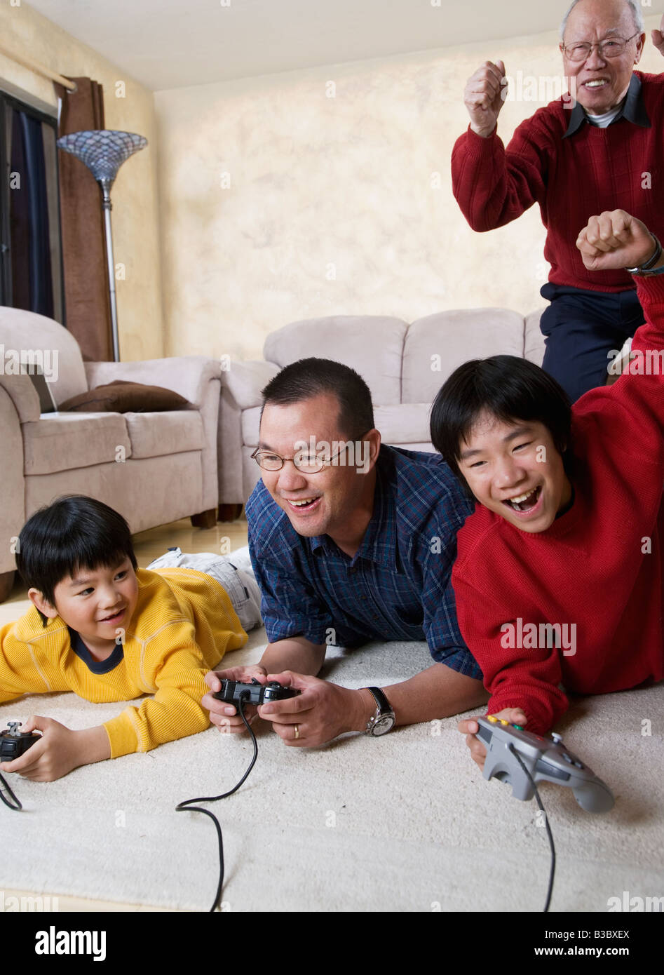 Multi-generational Asian family playing video games Stock Photo - Alamy