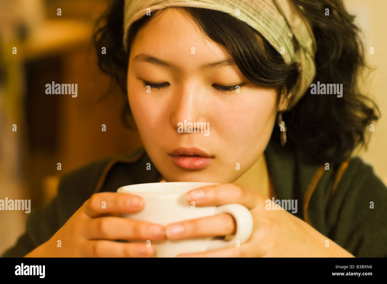 Asian woman drinking tea Stock Photo - Alamy