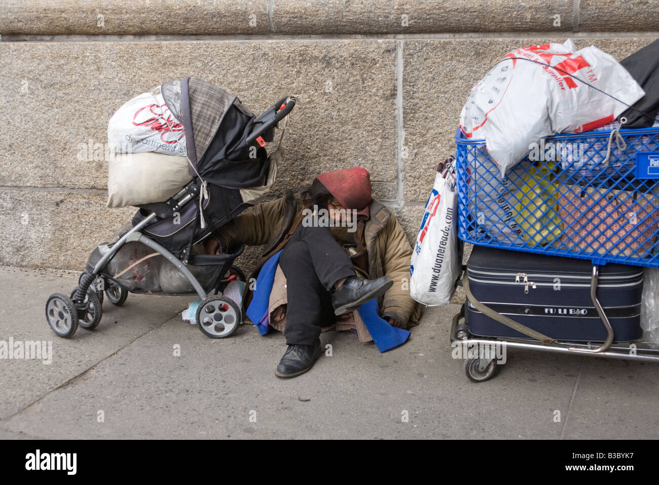 Homeless Chinese man sleeping next to his belongings in the Chinatown ...