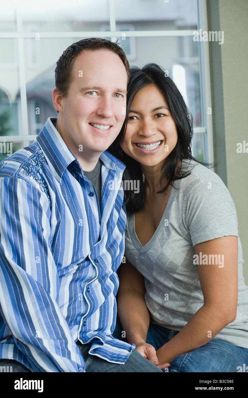 Mixed Race couple hugging Stock Photo - Alamy