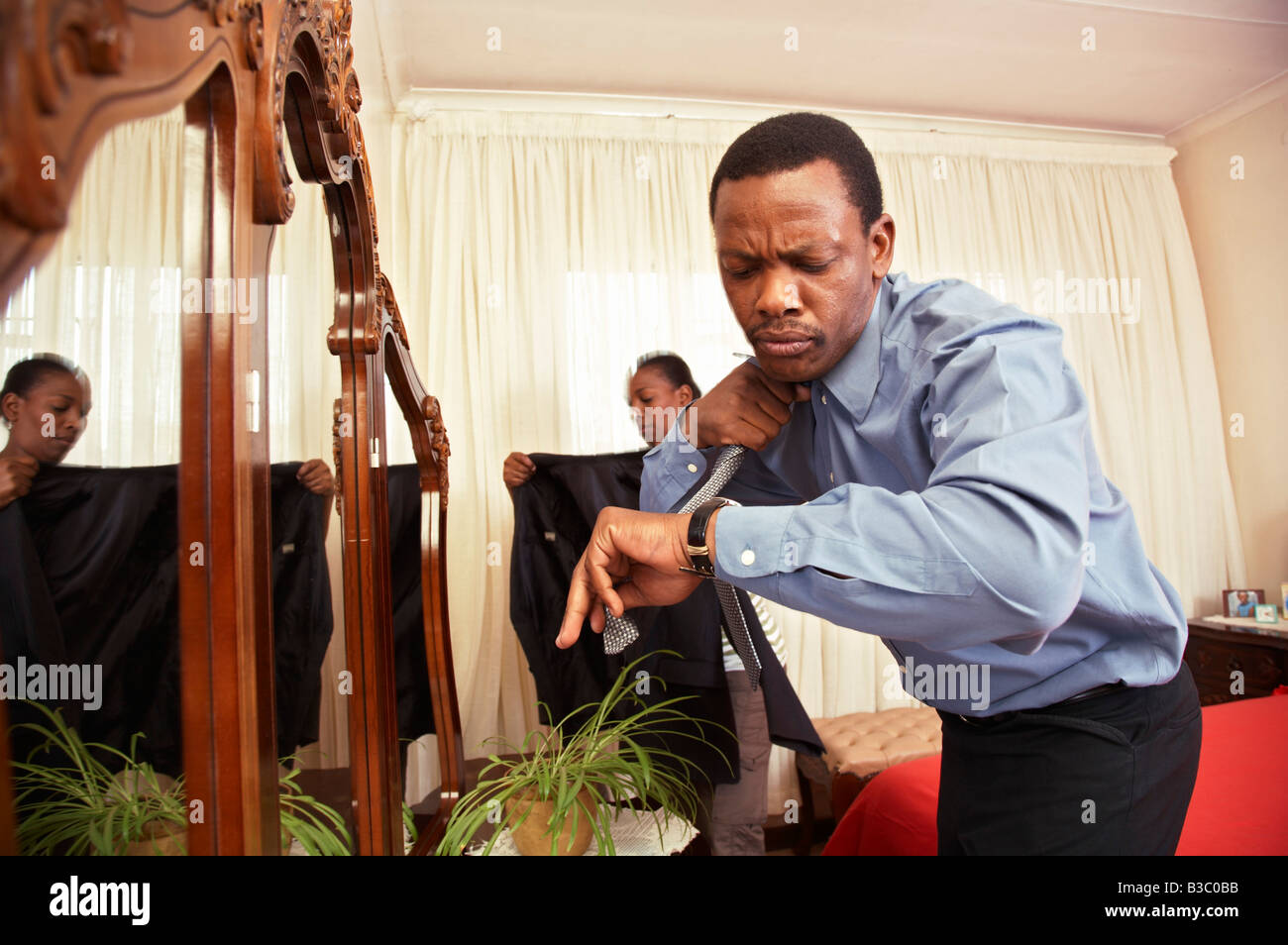 Man getting dressed, checking time Stock Photo - Alamy