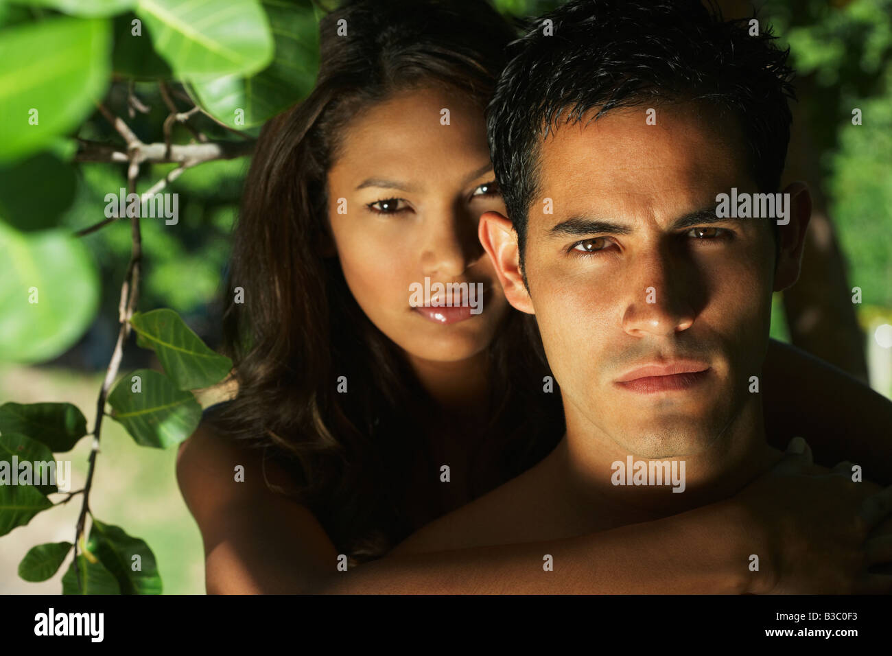 Hispanic couple hugging Stock Photo - Alamy