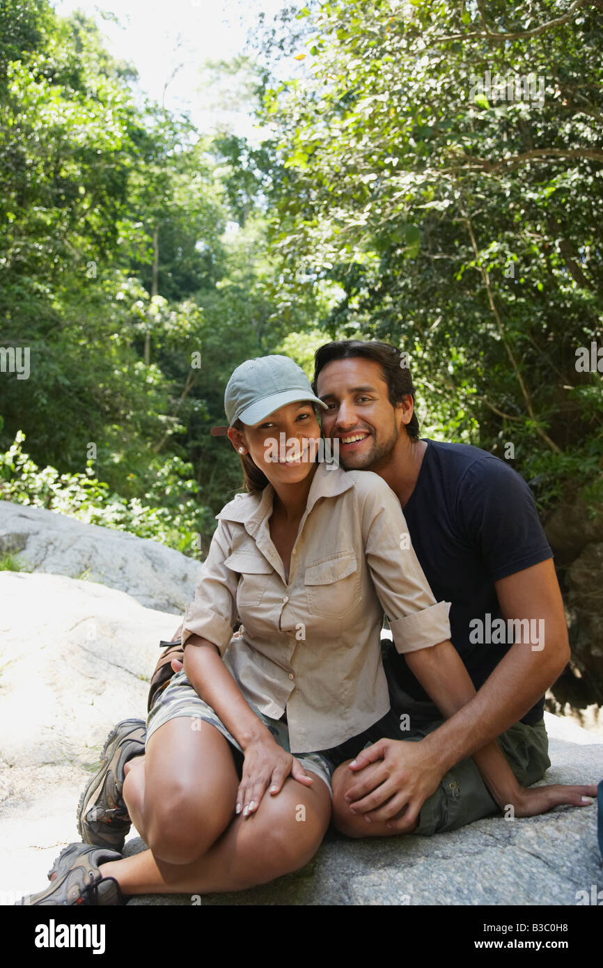 Hispanic couple hugging on rocks Stock Photo - Alamy