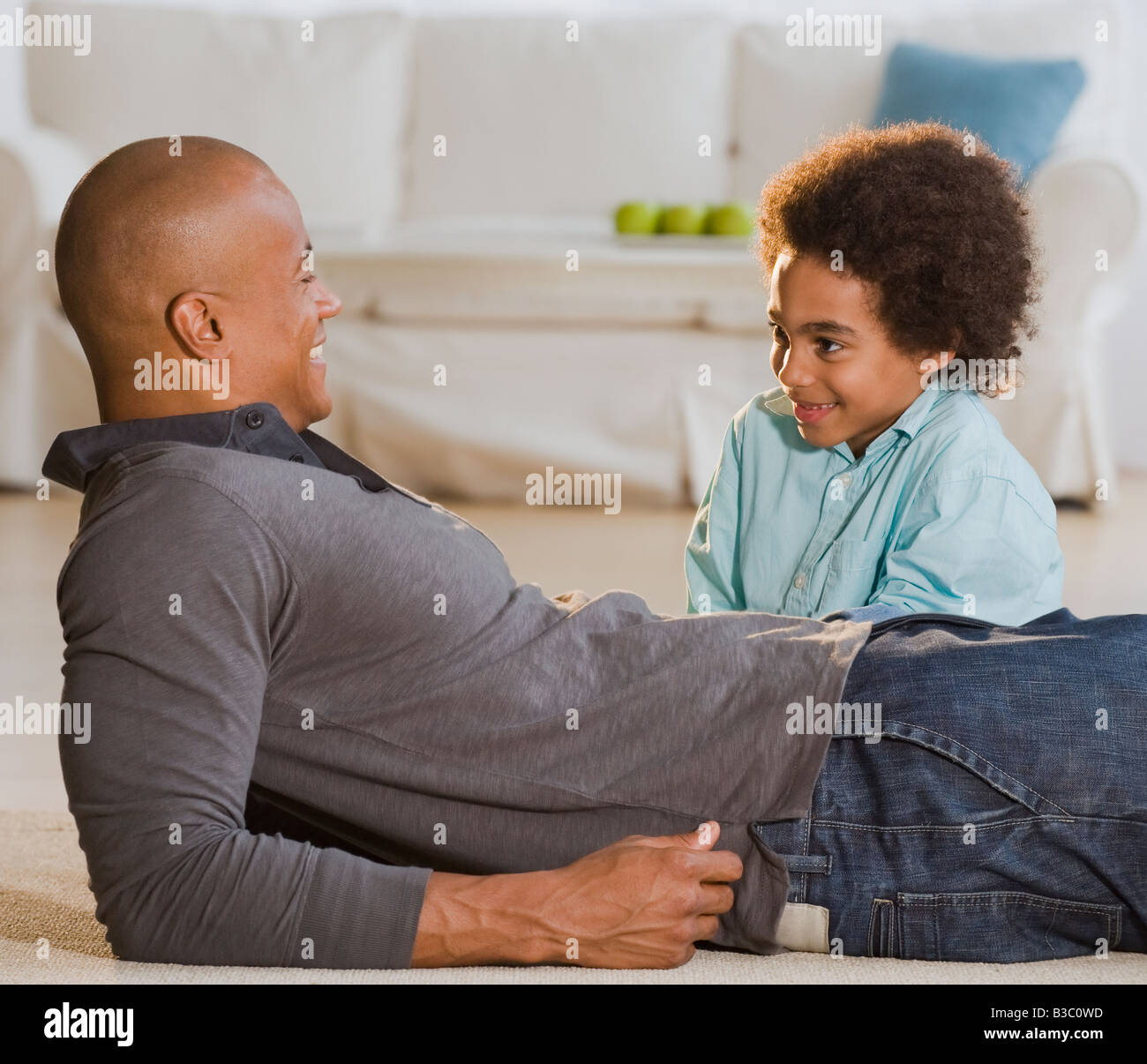 African father and son smiling at each other Stock Photo - Alamy