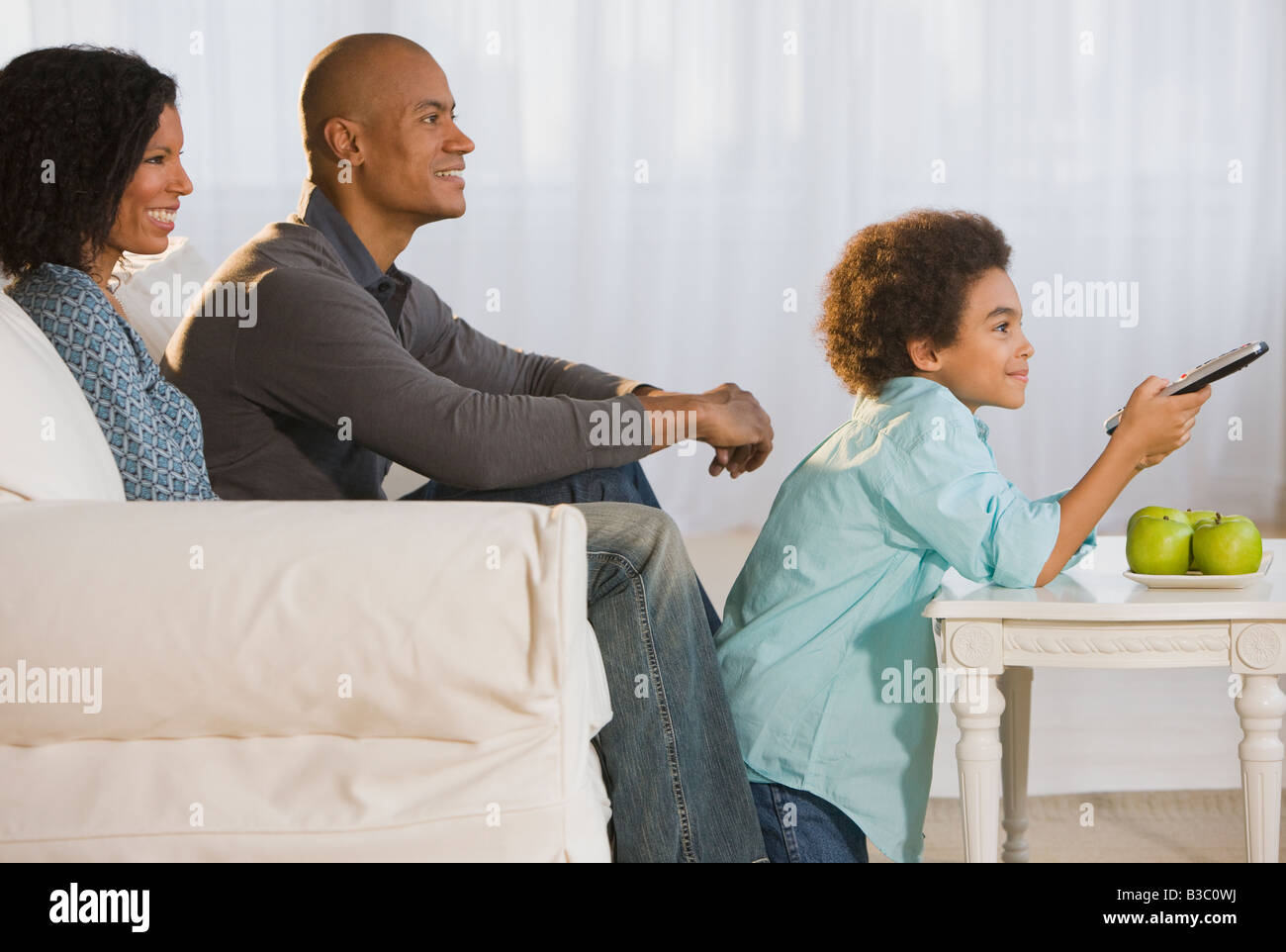 African family watching television Stock Photo - Alamy