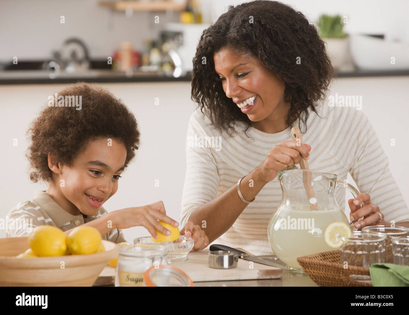 African mother and son making lemonade Stock Photo - Alamy