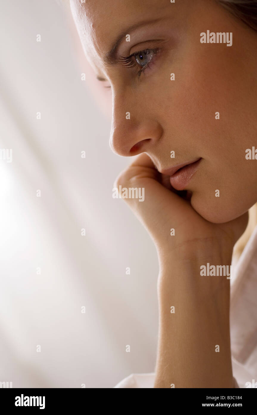 A young woman looking thoughtful Stock Photo - Alamy