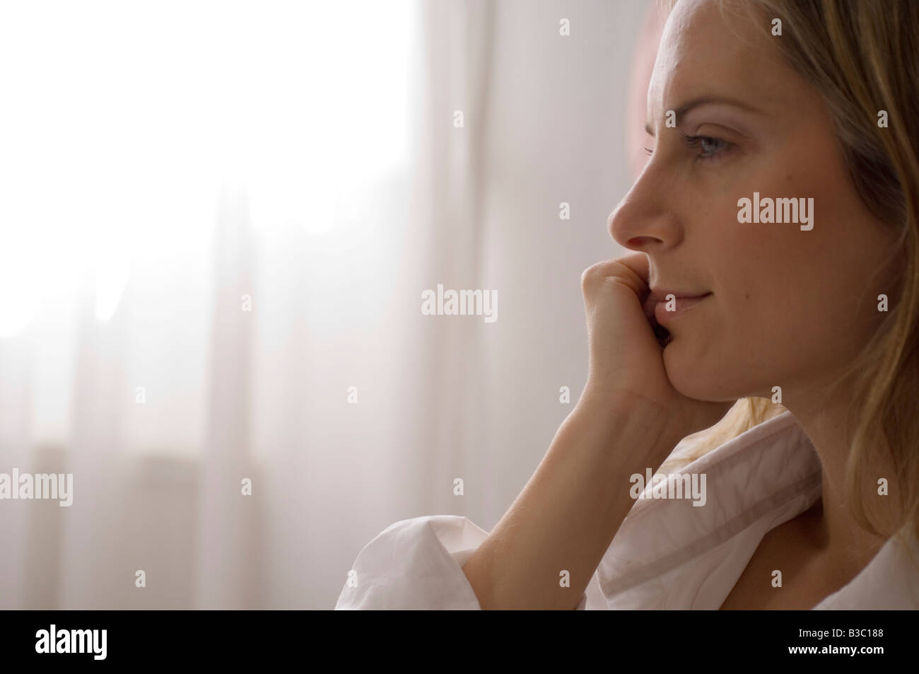 A young woman looking thoughtful Stock Photo - Alamy