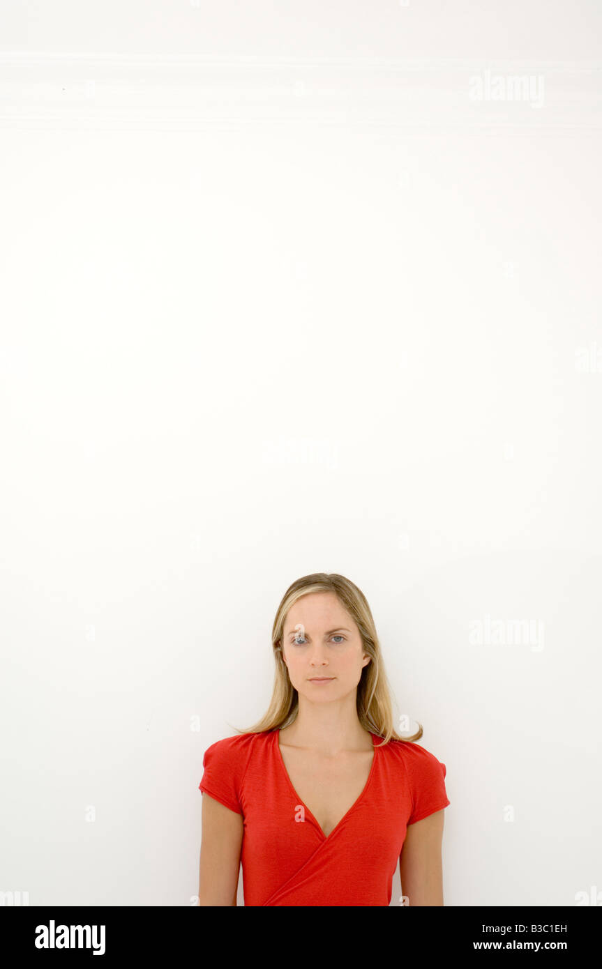 Portrait of a serious looking woman wearing a red dress Stock Photo - Alamy