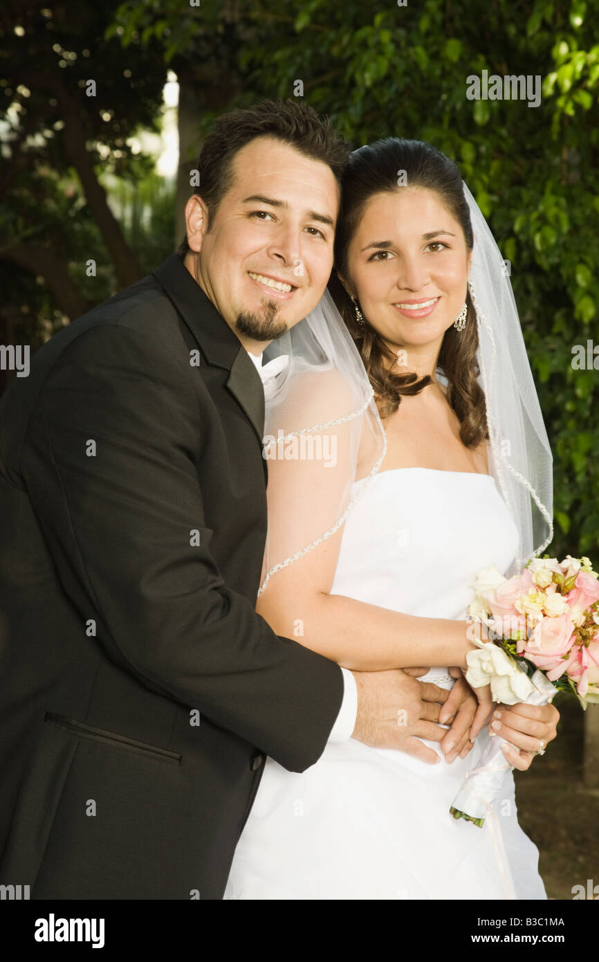 Hispanic newlyweds hugging Stock Photo - Alamy
