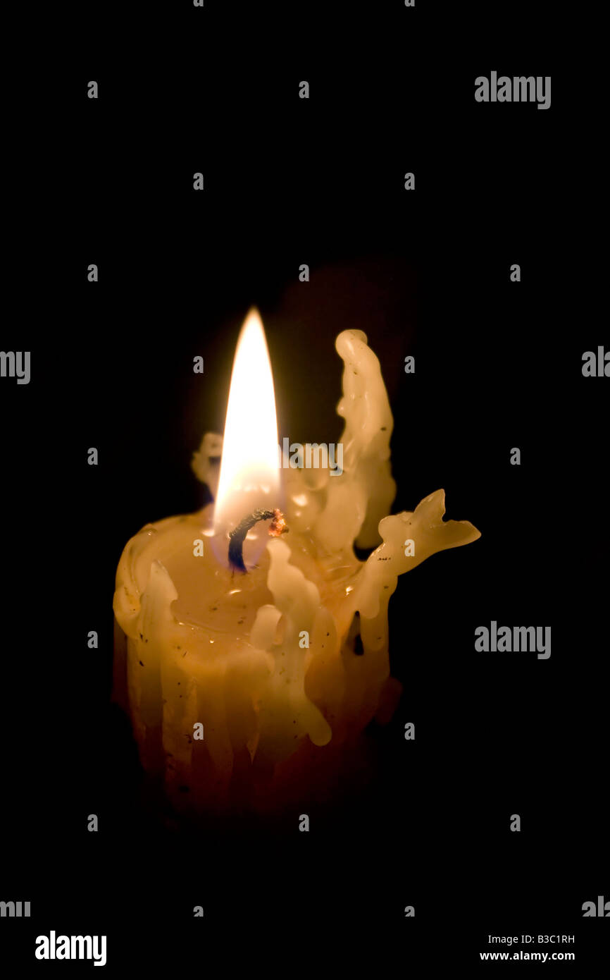 A creepy old candlestick burns on as it melts down little by little ...