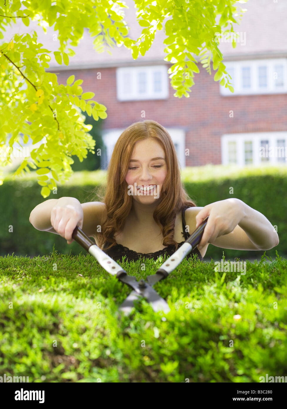 Woman cutting hedge hi-res stock photography and images - Alamy