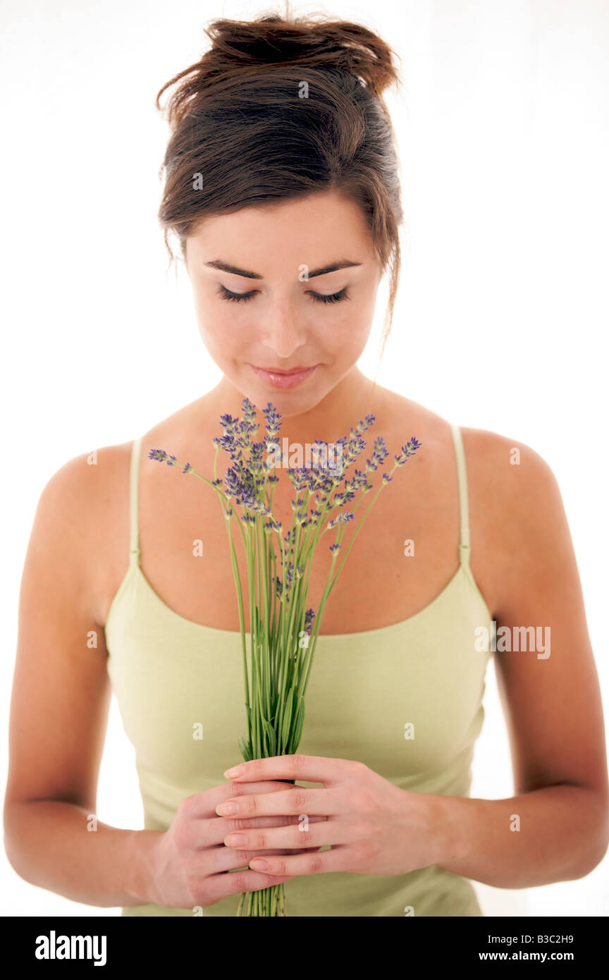A woman smelling lavender in her hands Stock Photo - Alamy