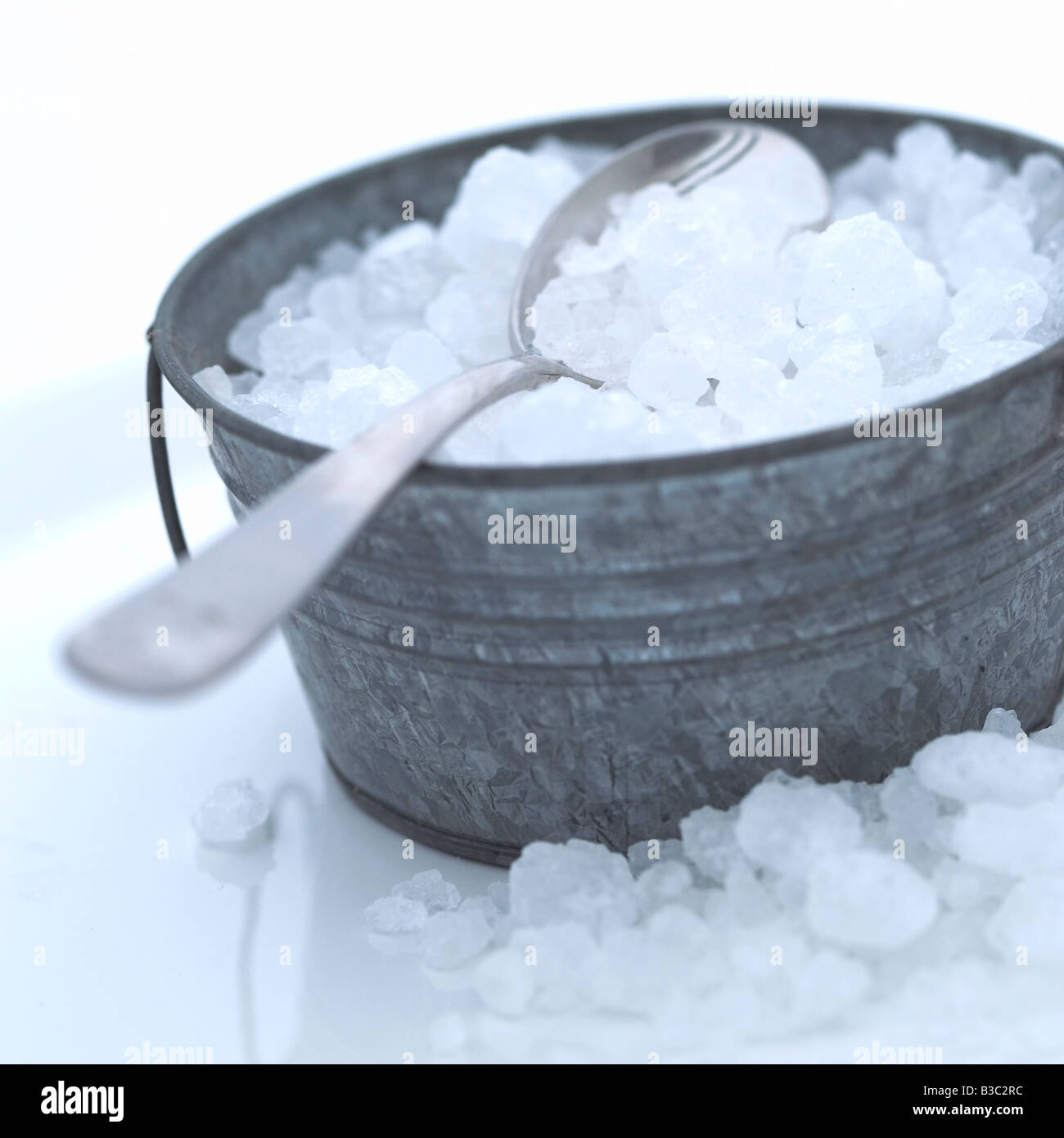 A small tub of rock salt and spoon Stock Photo - Alamy