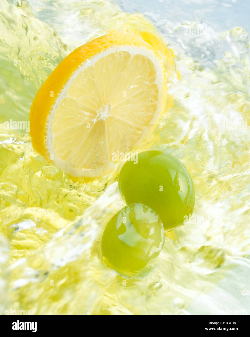 A slice of lemon and grapes in juice Stock Photo - Alamy