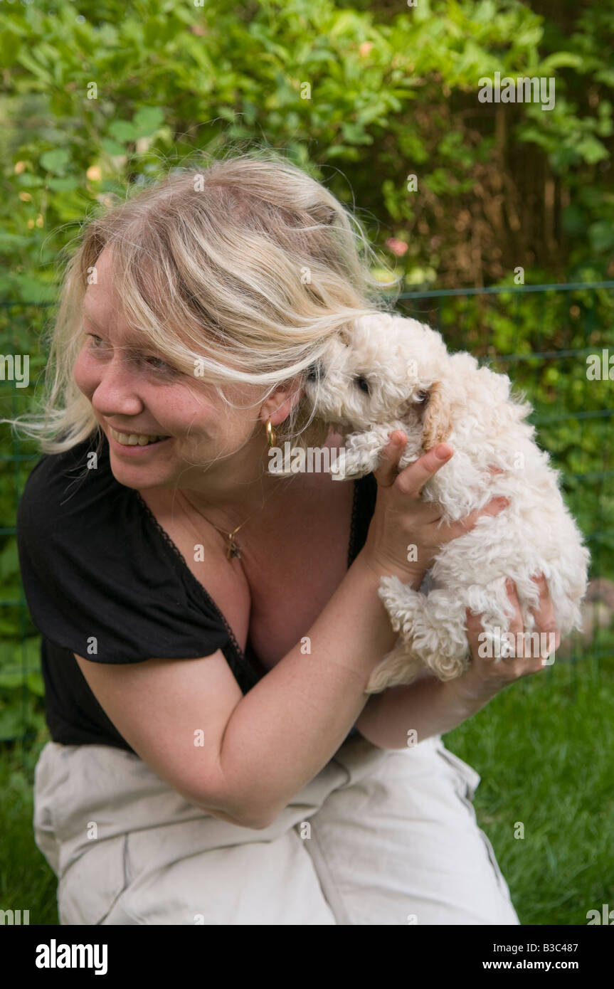 A woman with her poodle puppy Stock Photo - Alamy