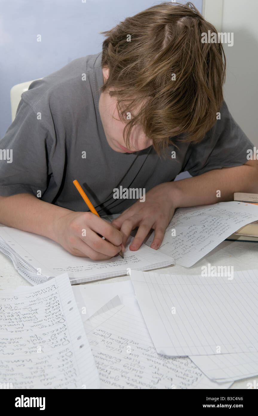 Young boy doing his homework Stock Photo - Alamy