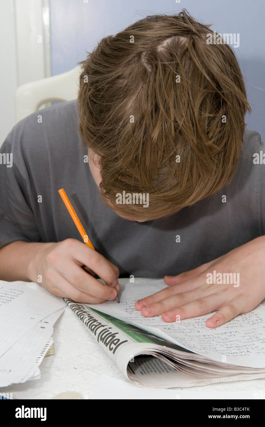 Young boy doing his homework Stock Photo - Alamy