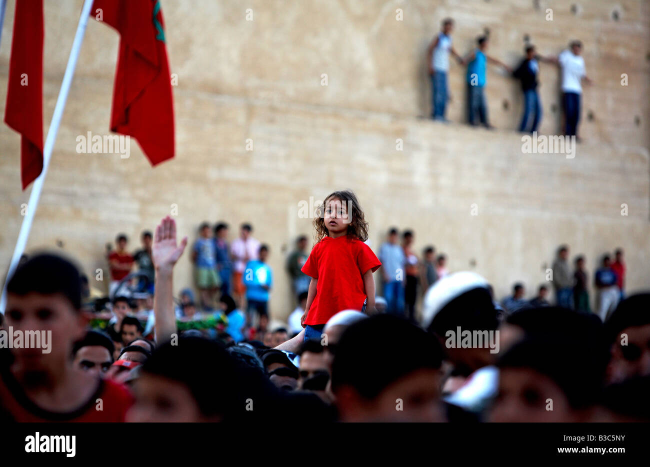Morocco, Fes. Against the backdrop of the ancient walls of Fes, a girl ...