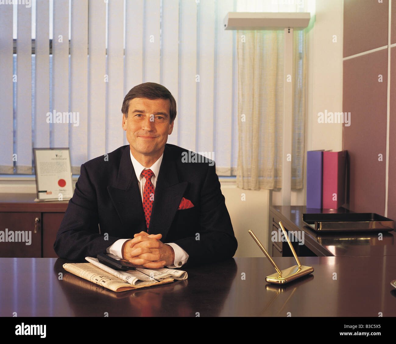 Front view of smiling business man sitting in office Stock Photo - Alamy