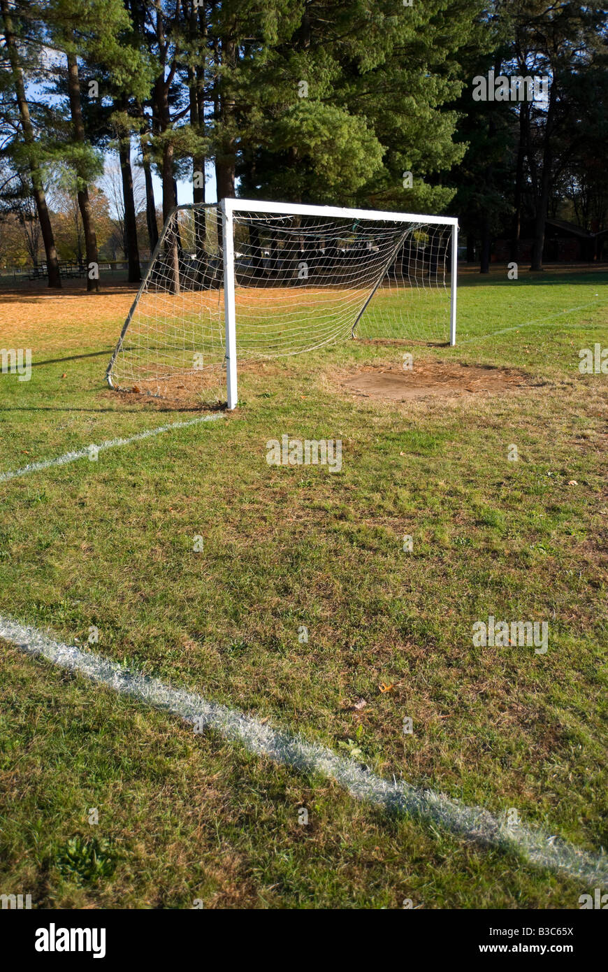 A soccer goal sits at the end empty field at the park Stock Photo - Alamy