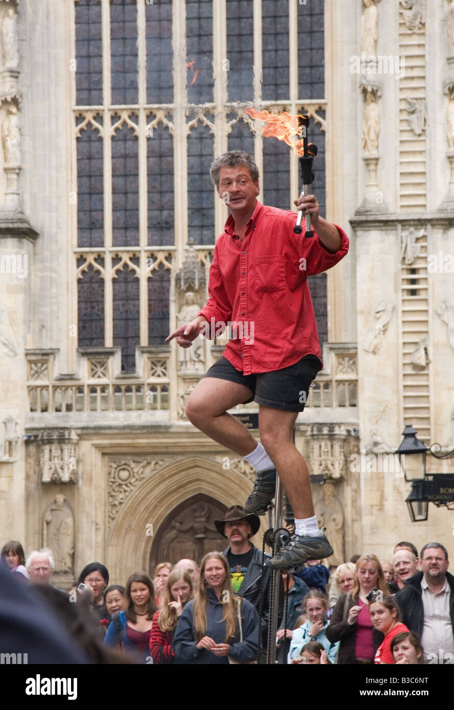 A juggler performing on a monocycle in front of Bath Abbey, UK 2008 ...
