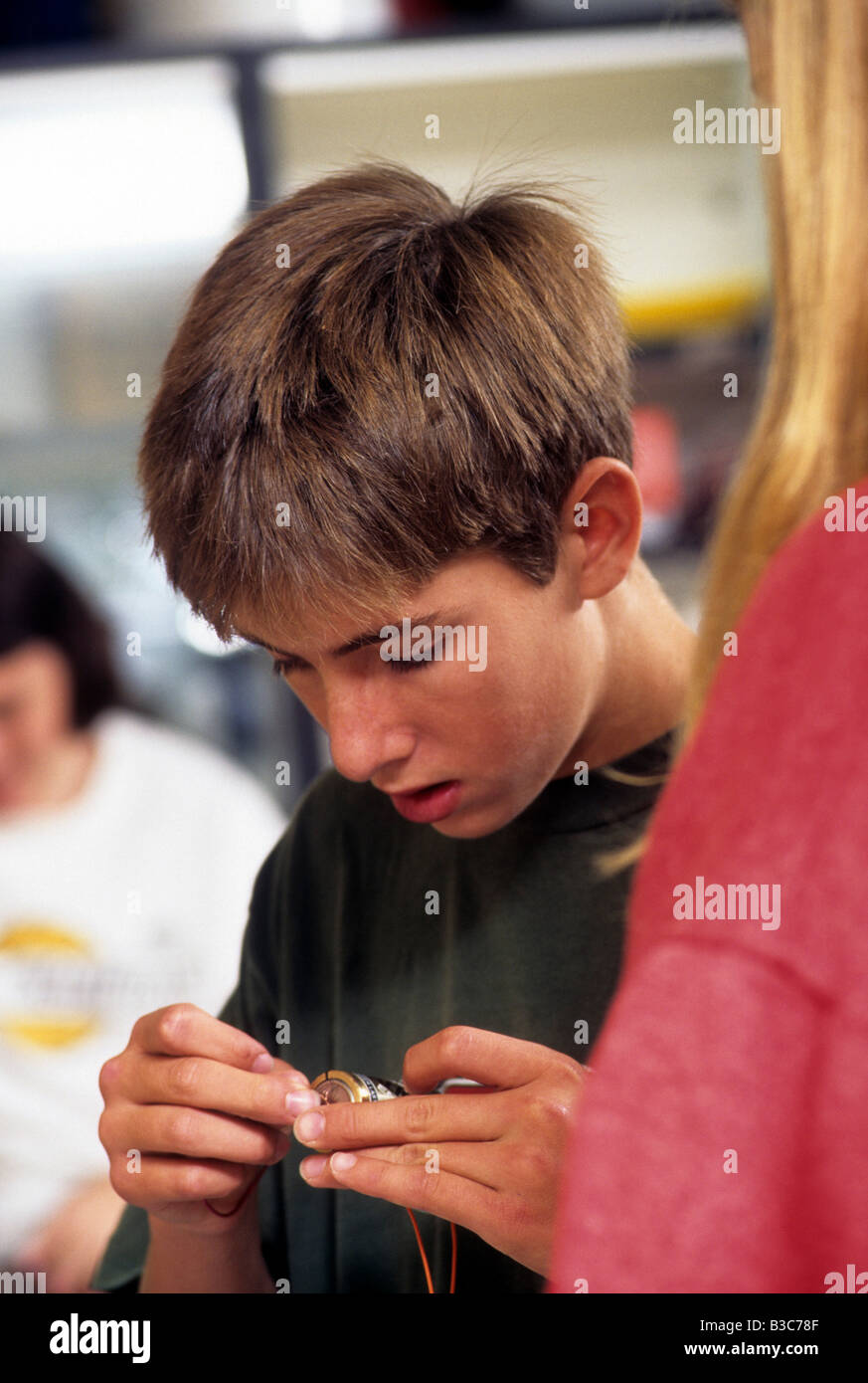 Teen boy works on science project in high school class Stock Photo - Alamy