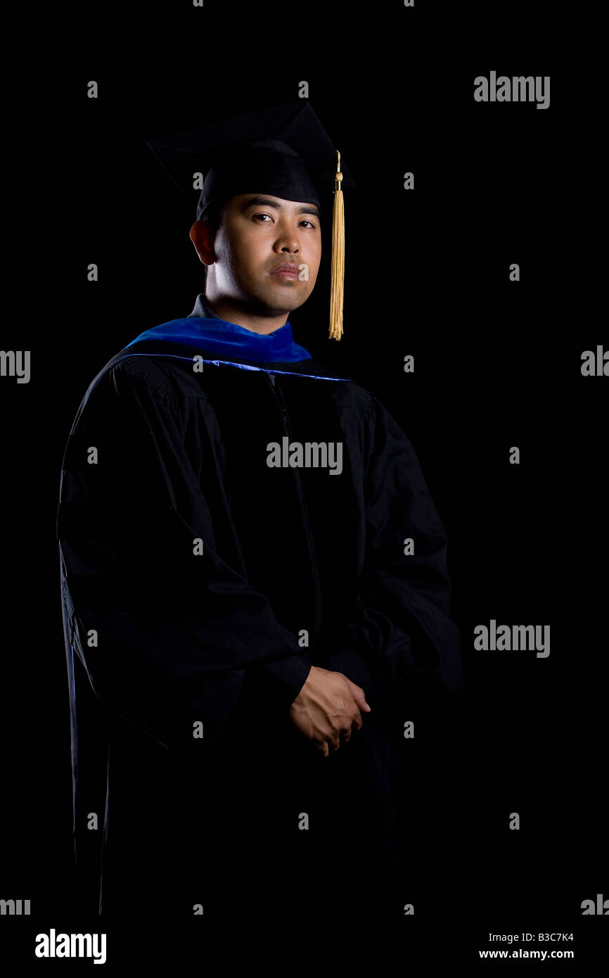 Low key image of a male model in graduation robes and regalia Stock ...
