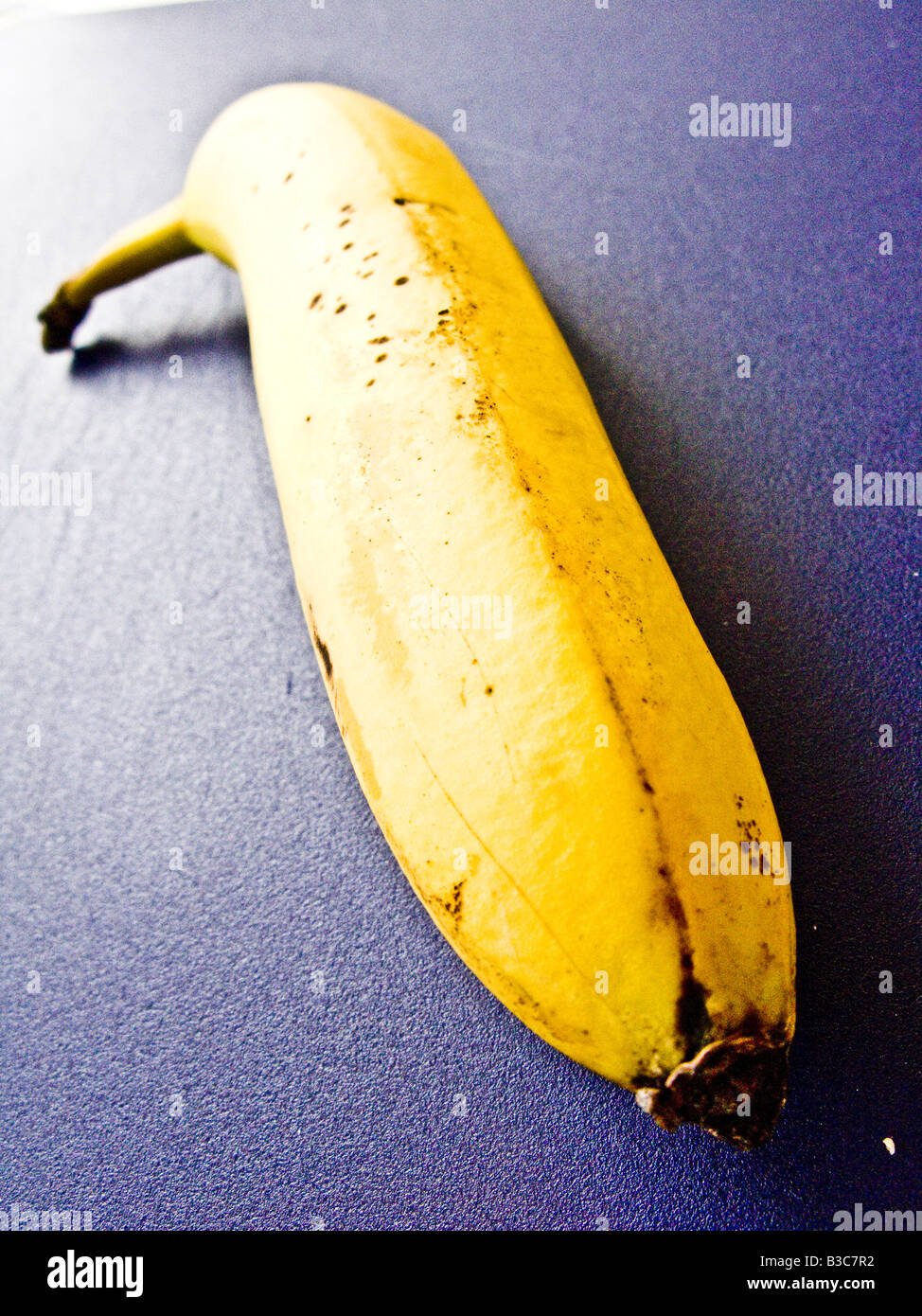 one banana on blue background Stock Photo - Alamy