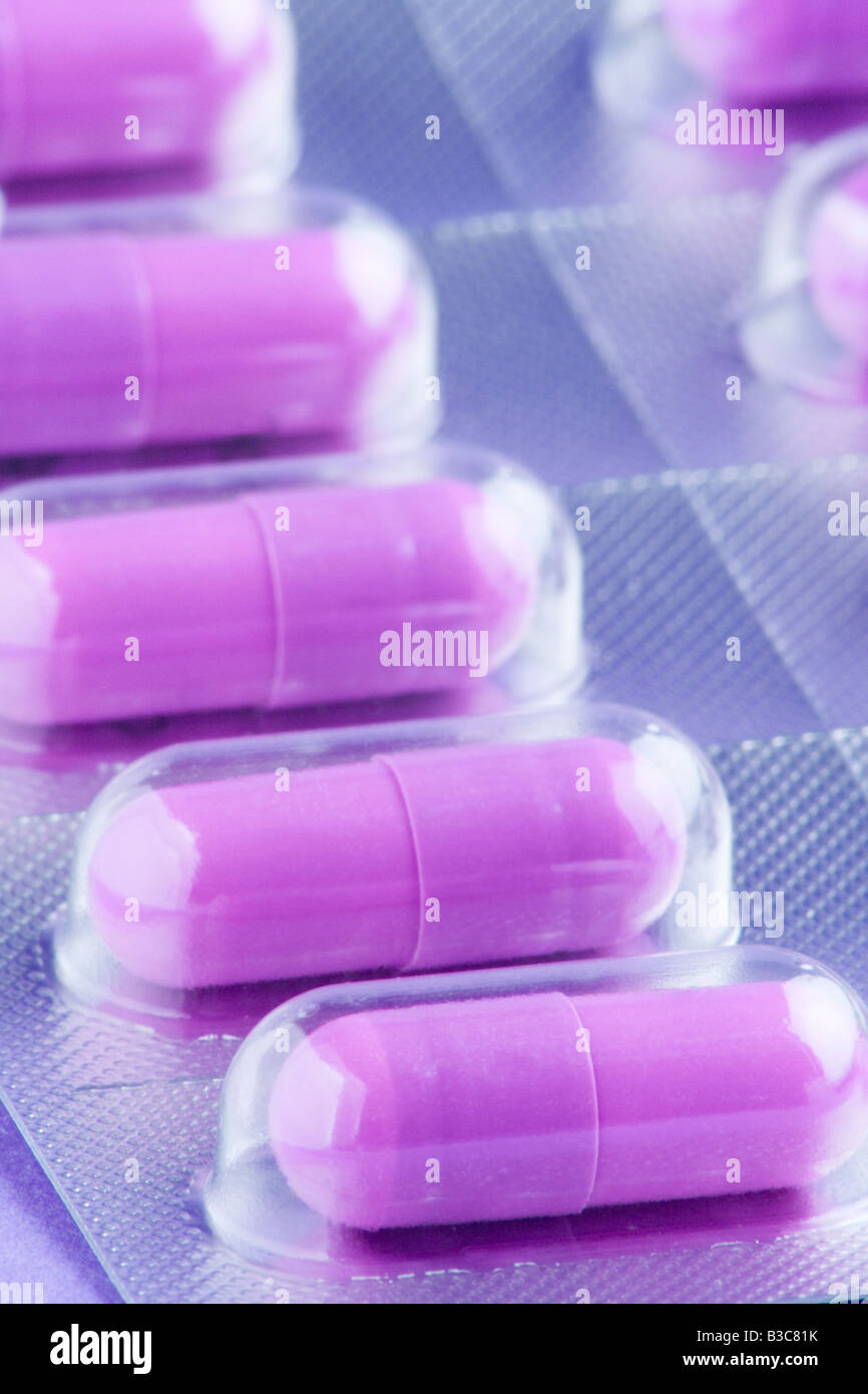 Pink capsules in a blister pack Stock Photo - Alamy