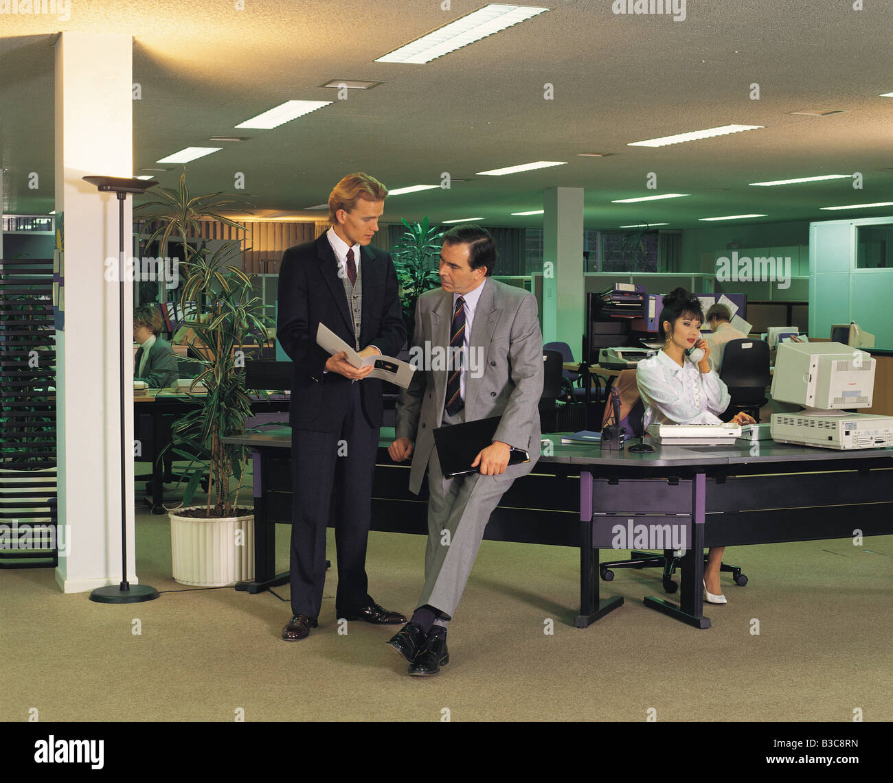 Businessmen discussing in office Stock Photo - Alamy