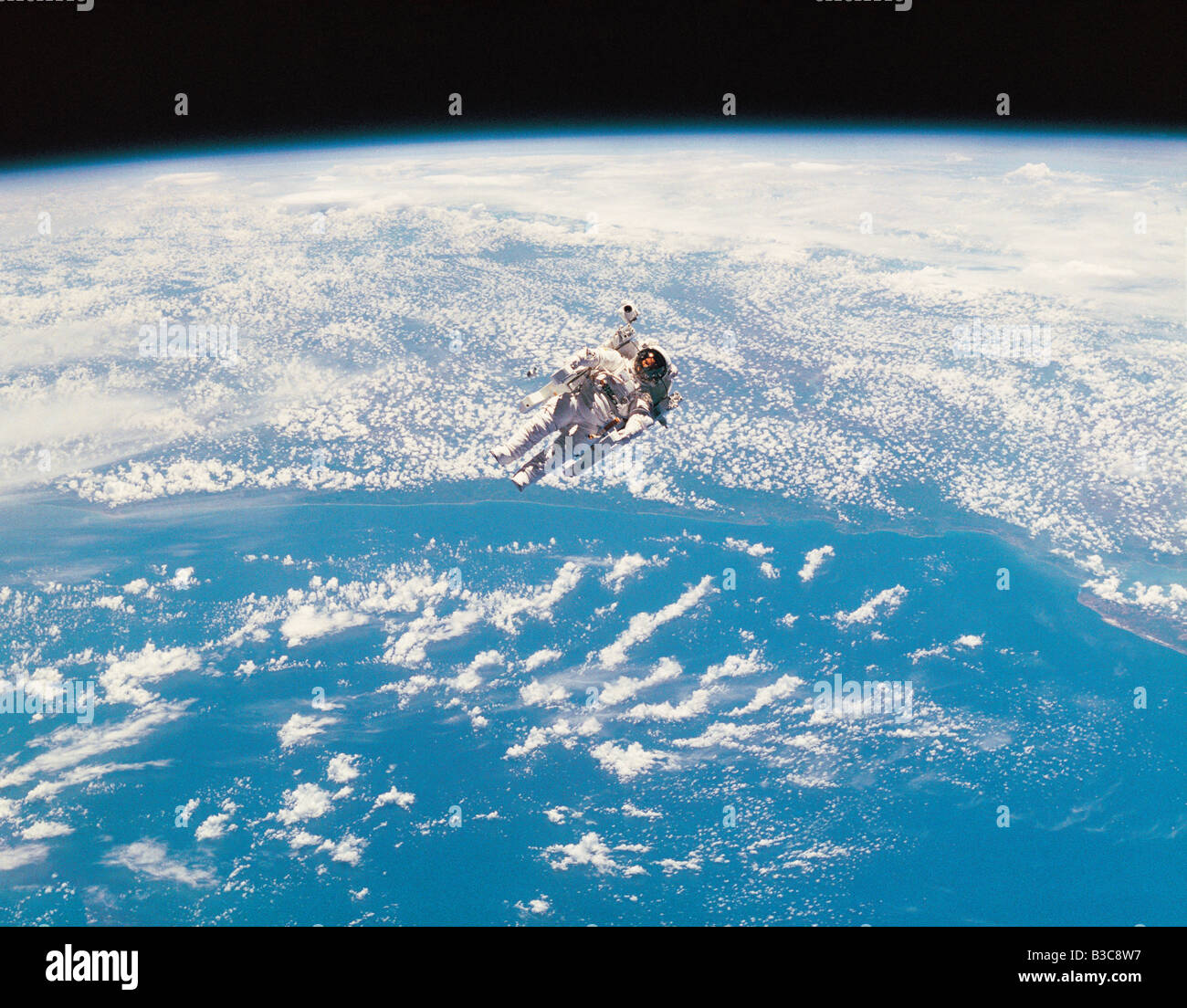 Astronaut floating in orbit above planet Earth in manned maneuvering ...