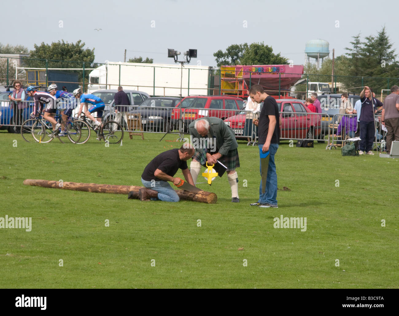 Officials shorten a caber at a Highland Games gathering. The caber was ...