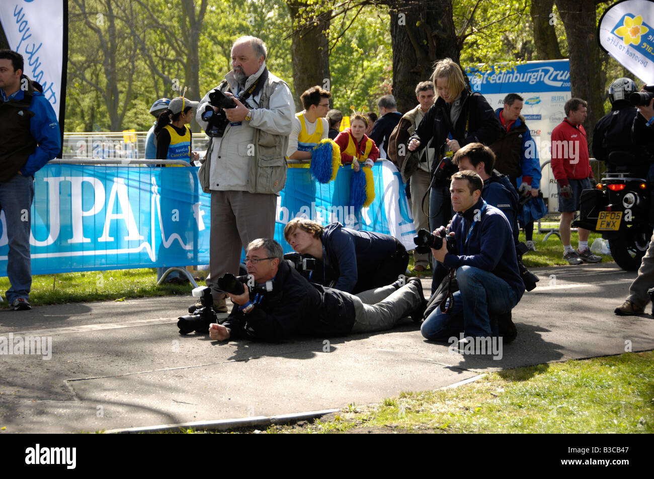 Photographers awaiting competitors to photograph at the finish line of ...