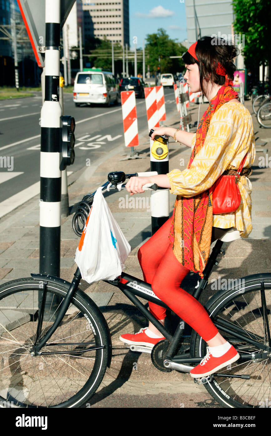Pretty extravagant teenage dutch girl riding bicycle street Rotterdam ...