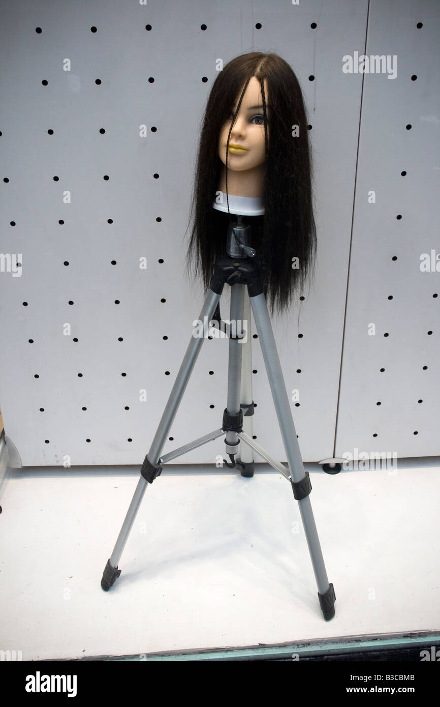 wig dummy in shop window paris france Stock Photo - Alamy
