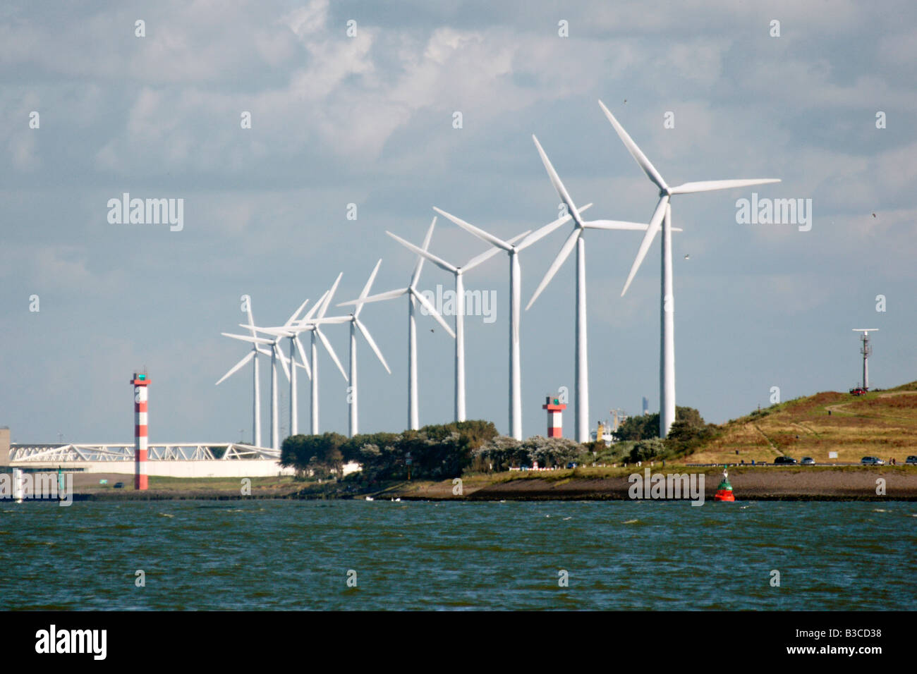 Wind turbines windfarm at Europoort port above Nieuwe Waterweg water ...