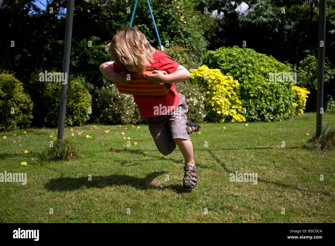 Boy twisting swing hi-res stock photography and images - Alamy