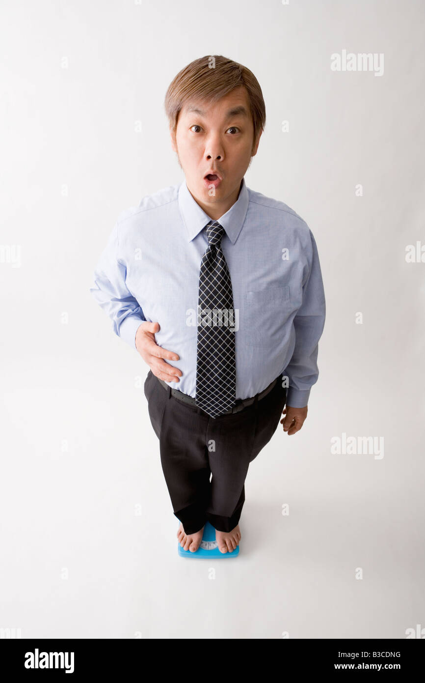 Fat man on scale hi-res stock photography and images - Alamy
